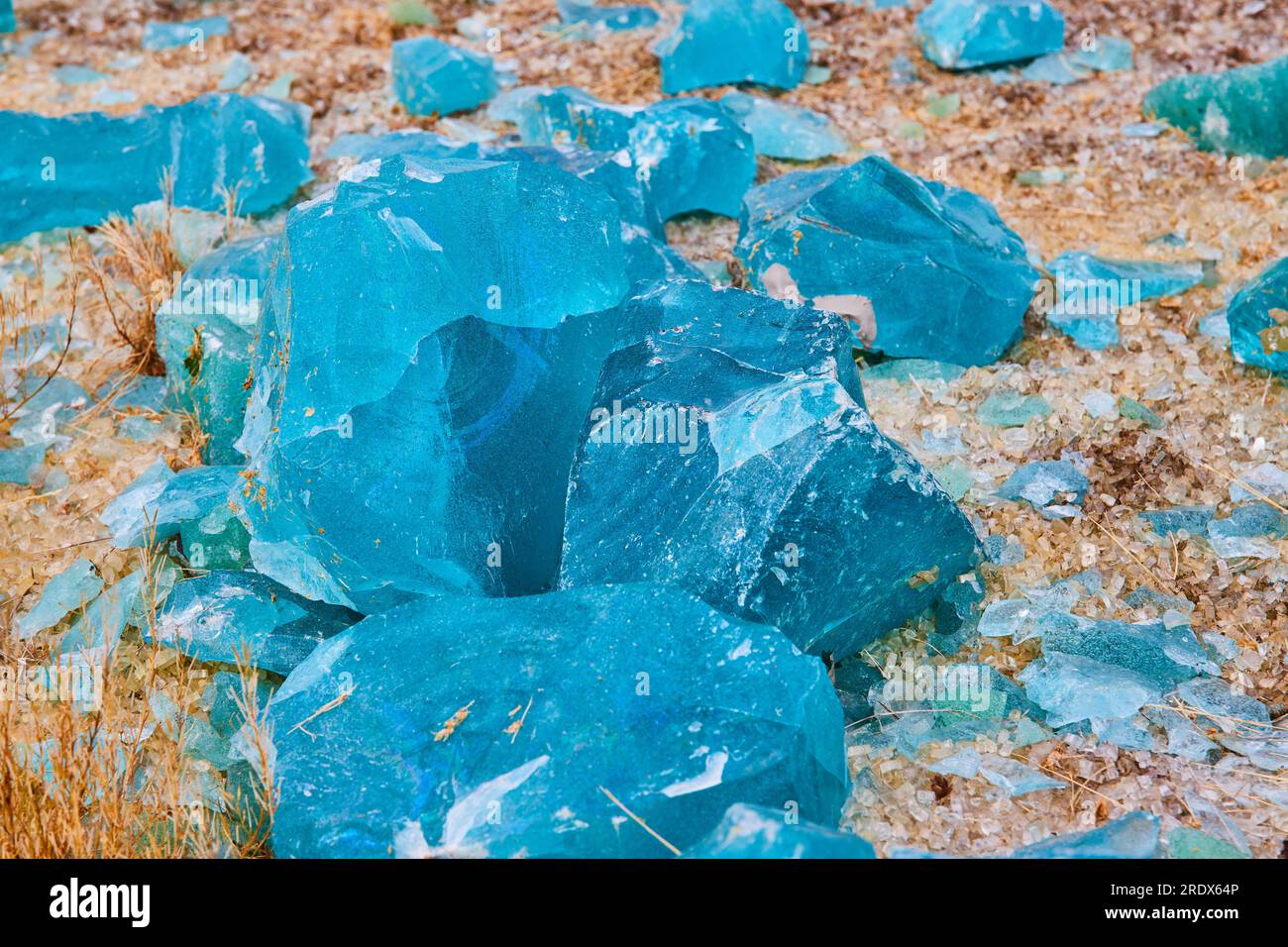 Gorgeous turquoise blue shards resting on a shore of broken clear glass ...