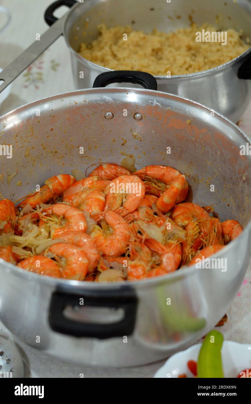 food table with Egyptian rice cooked on hot steam and cooked shrimps ...