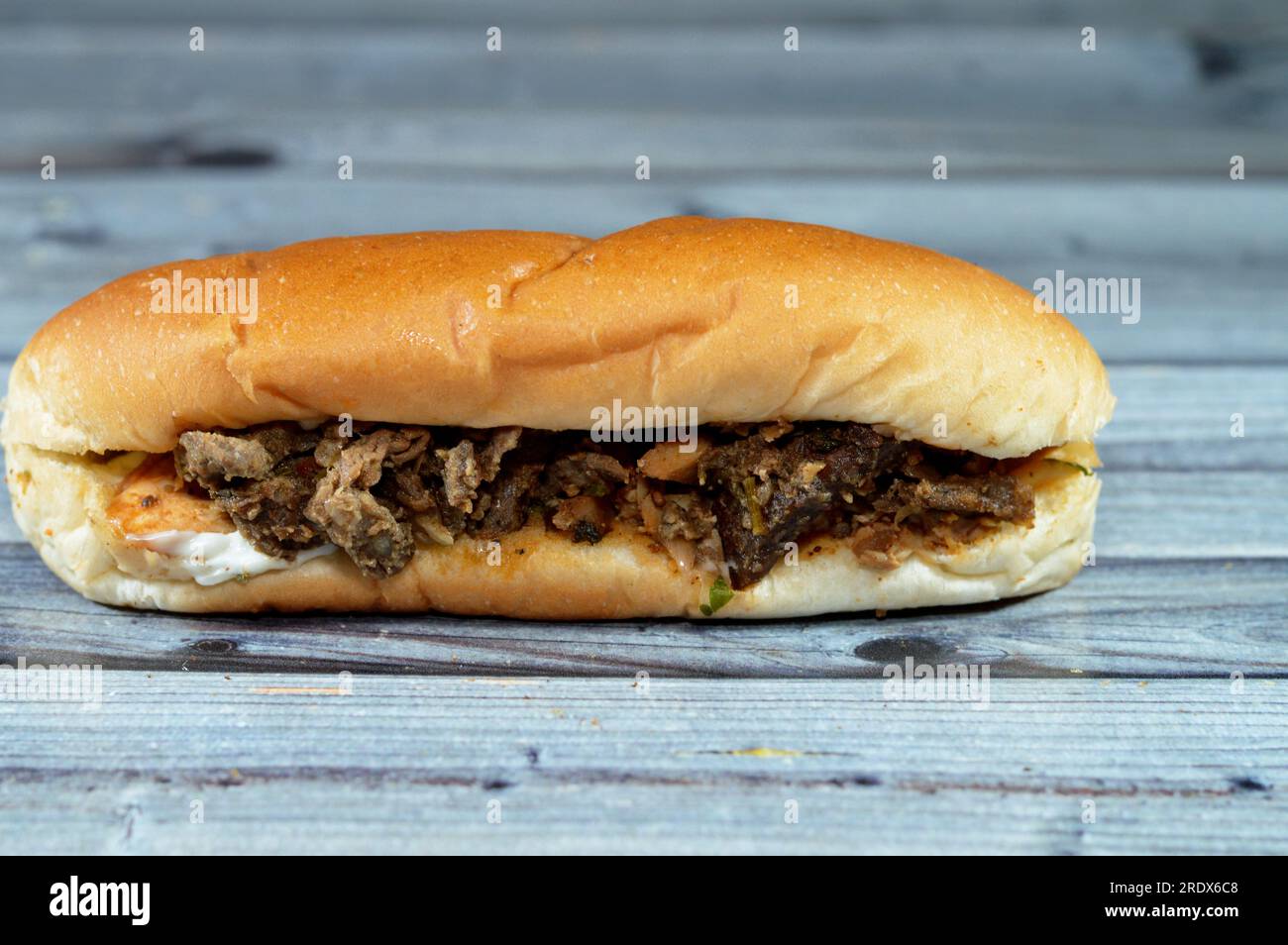 Beef meat shawarma sandwich in a bun, a popular Middle Eastern dish ...