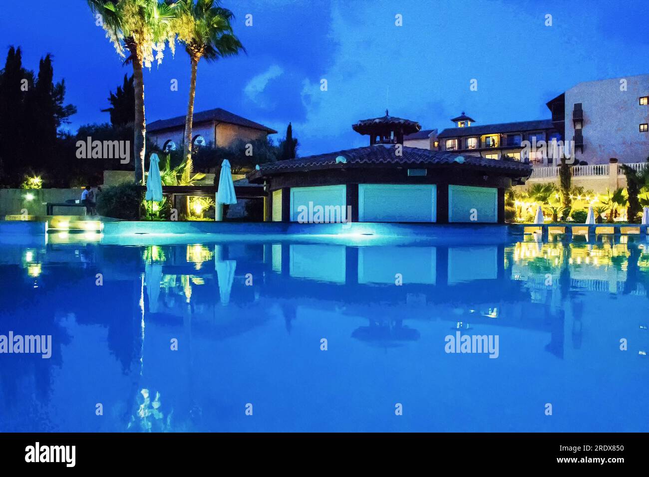 Night view on pool in twilights behind some pavilion ( bar ?) on Greek ...