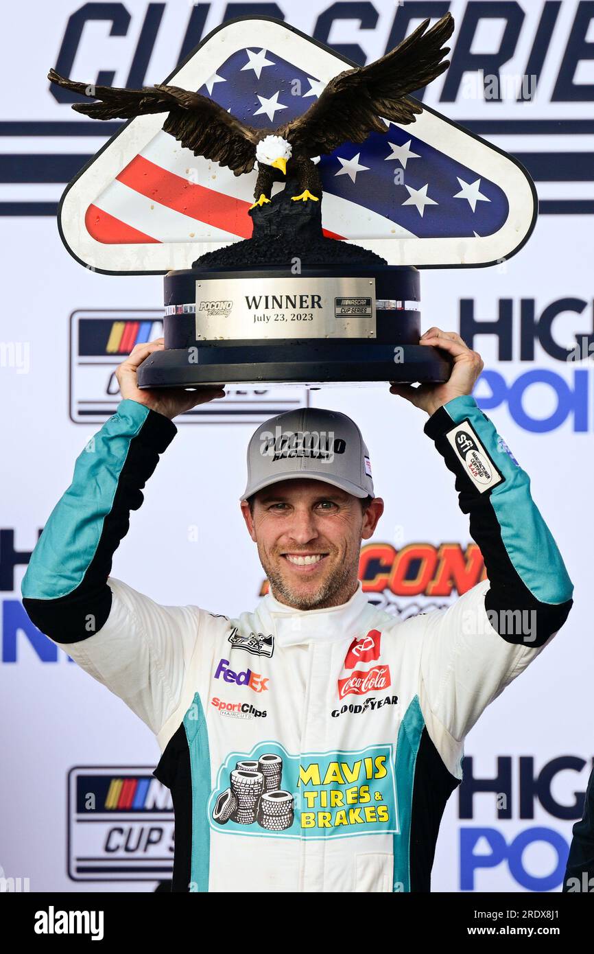 Denny Hamlin poses with the trophy in Victory Lane after winning a ...