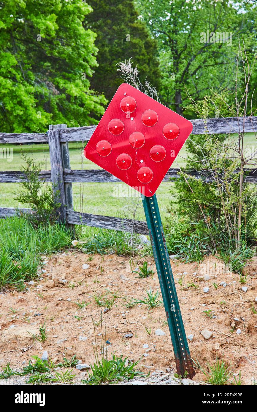 Diamond caution sign signaling dead end roadway next to dirt patch and ...