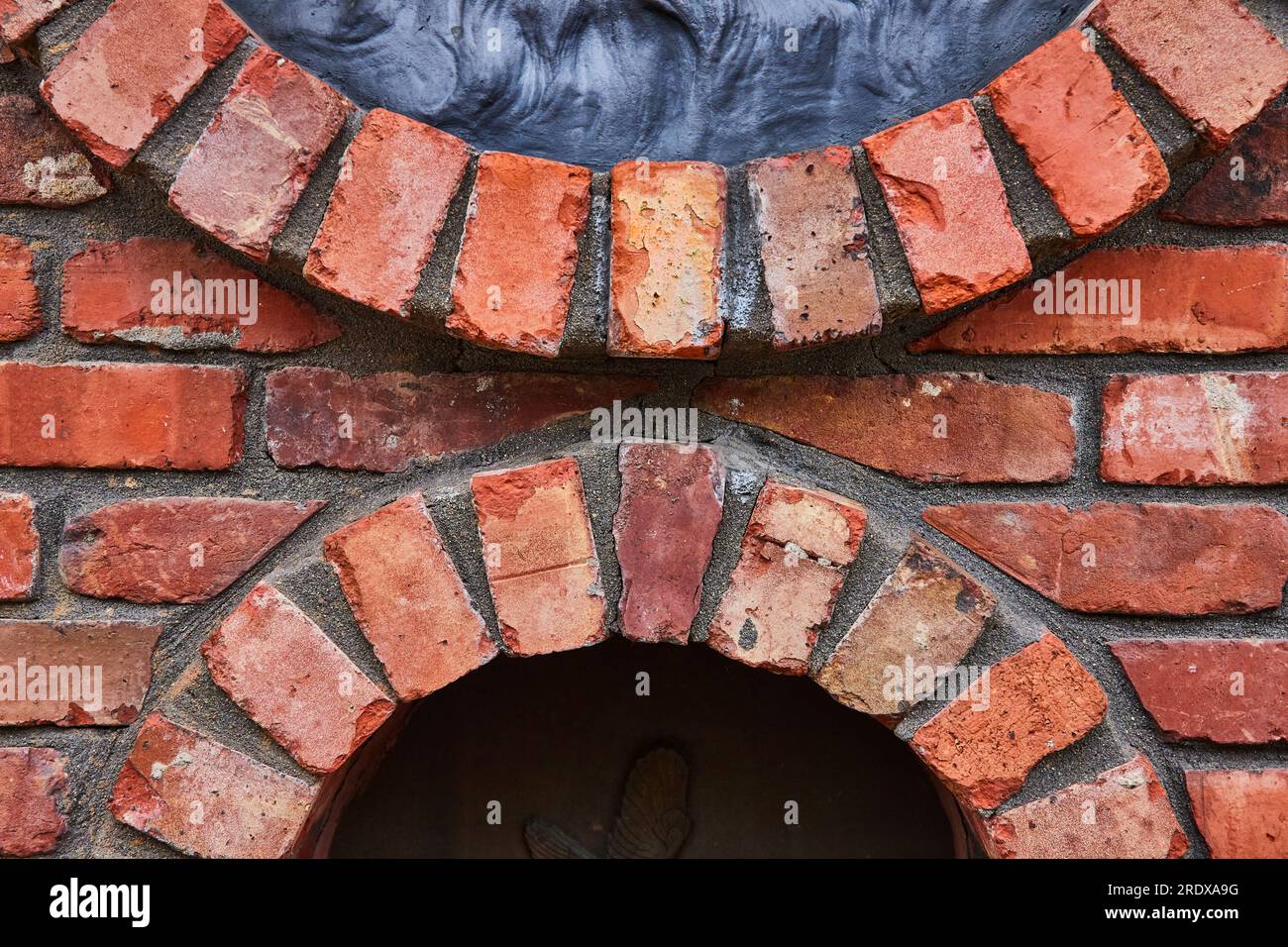 Horizontal red bricks with two opposing arches with partial motifs in ...