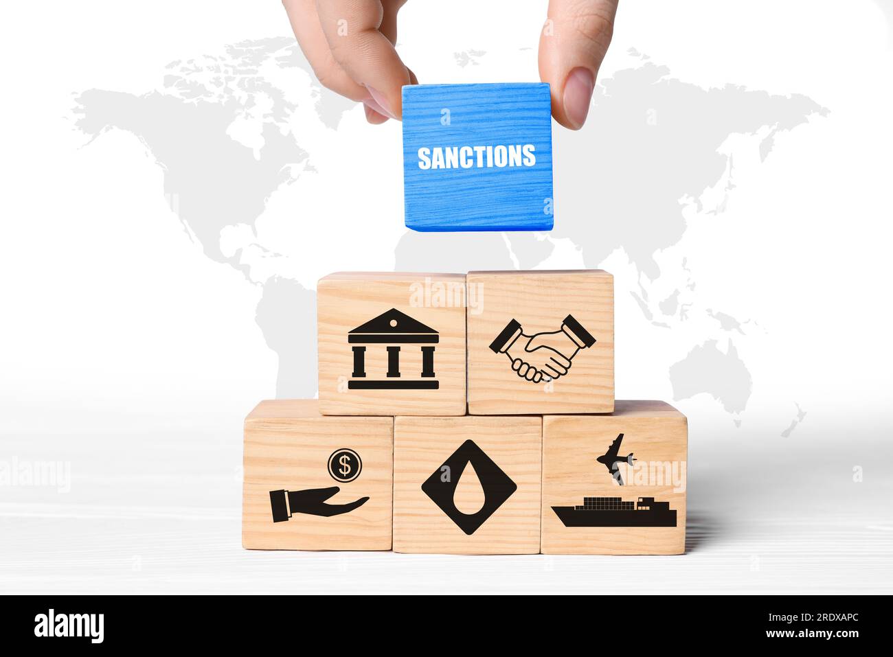 Economic sanctions. Woman building pyramid of wooden cubes, closeup ...
