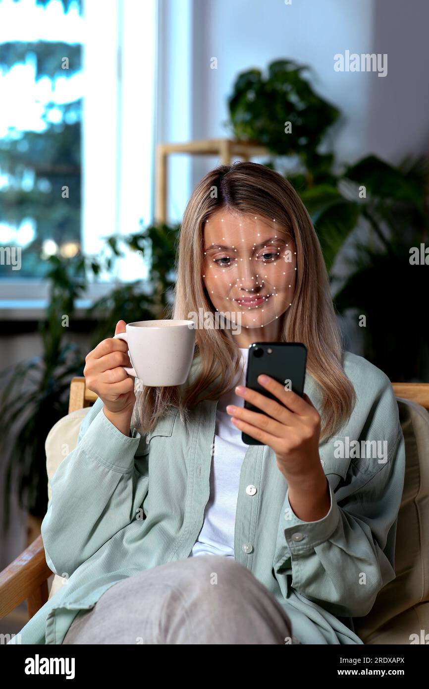 Woman Using Smartphone With Facial Recognition System At Home Security Application Scanning Her