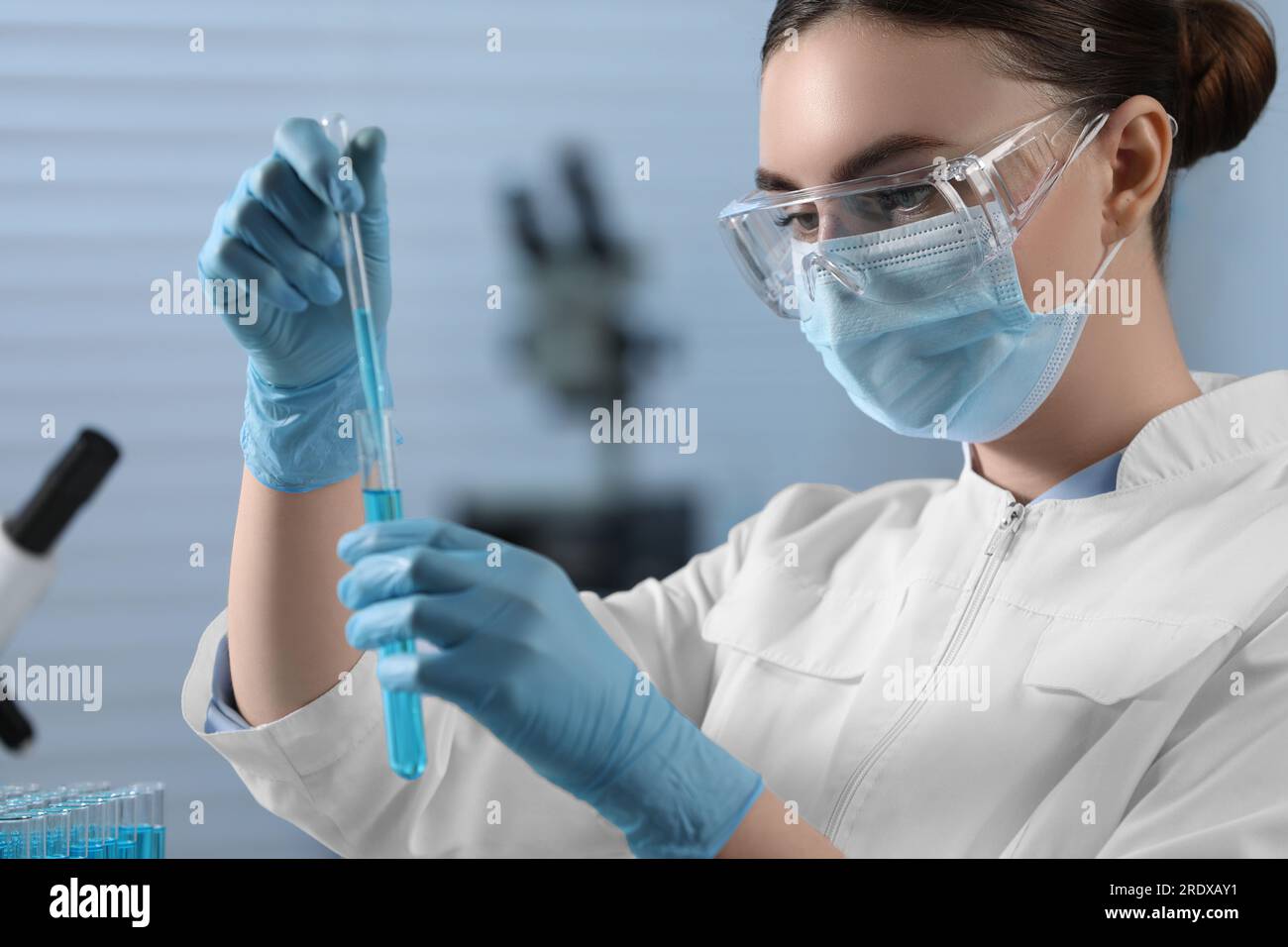 Scientist taking sample with dropper from test tube in laboratory Stock ...