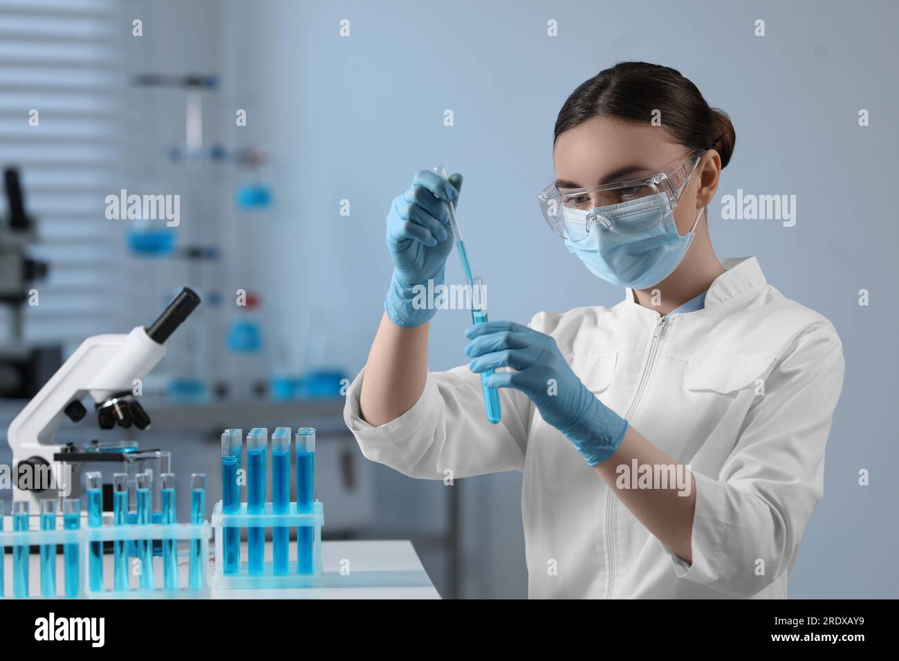 Scientist taking sample with dropper from test tube in laboratory Stock ...
