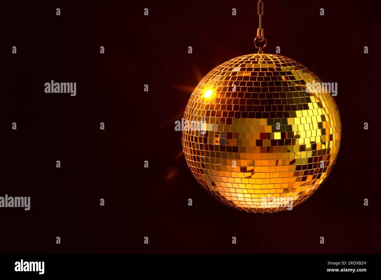 Shiny bright disco ball under orange light, space for text Stock Photo ...
