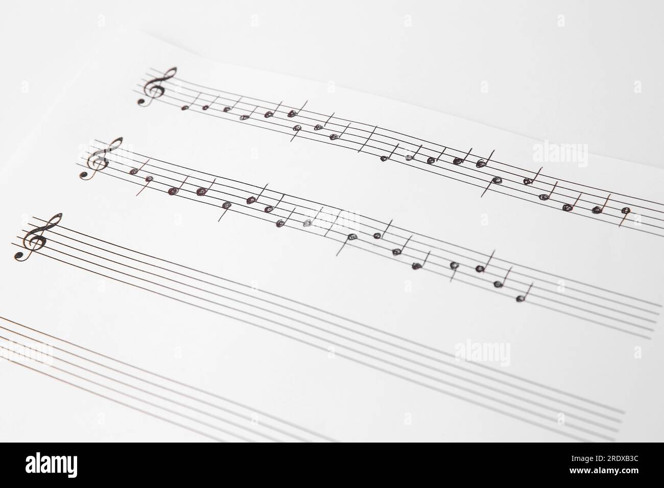 Sheet of paper with music notes on white background, closeup view Stock ...