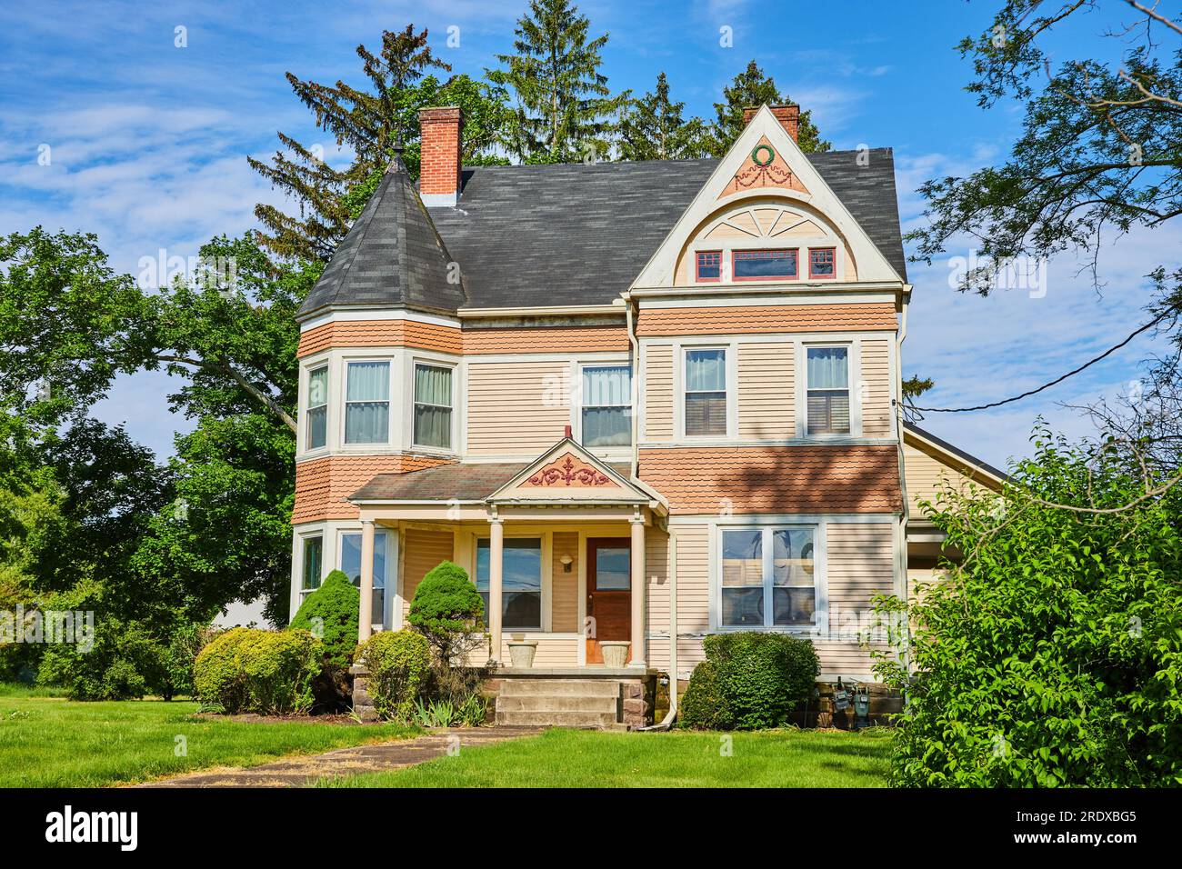 Old fashioned home in rural area with partially cloudy blue skies Stock ...