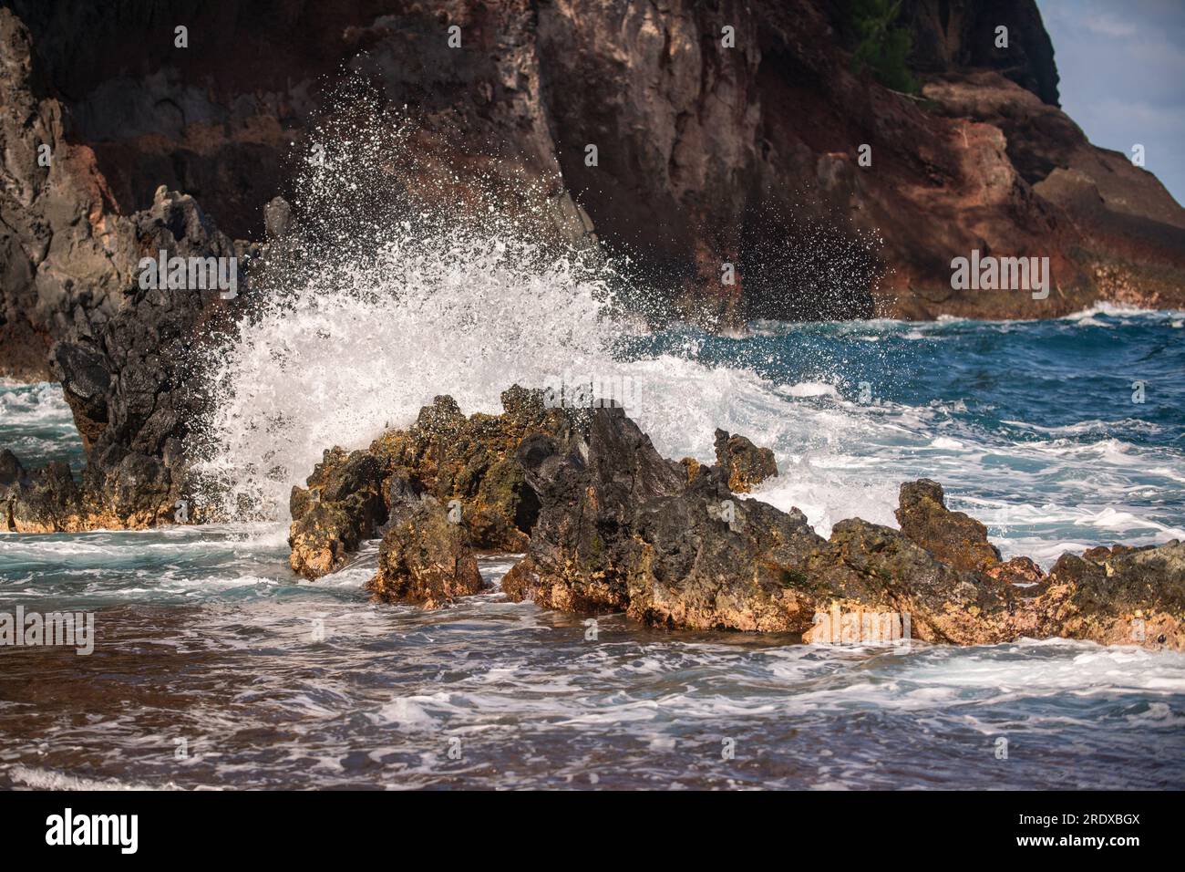 Sea collides with the stones and sand of a beach. Sea waves lash line ...