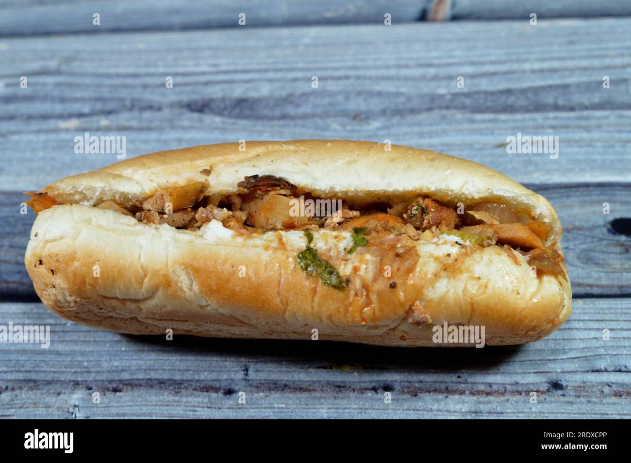 Chicken shawarma sandwich in a a bun, a popular Middle Eastern dish ...