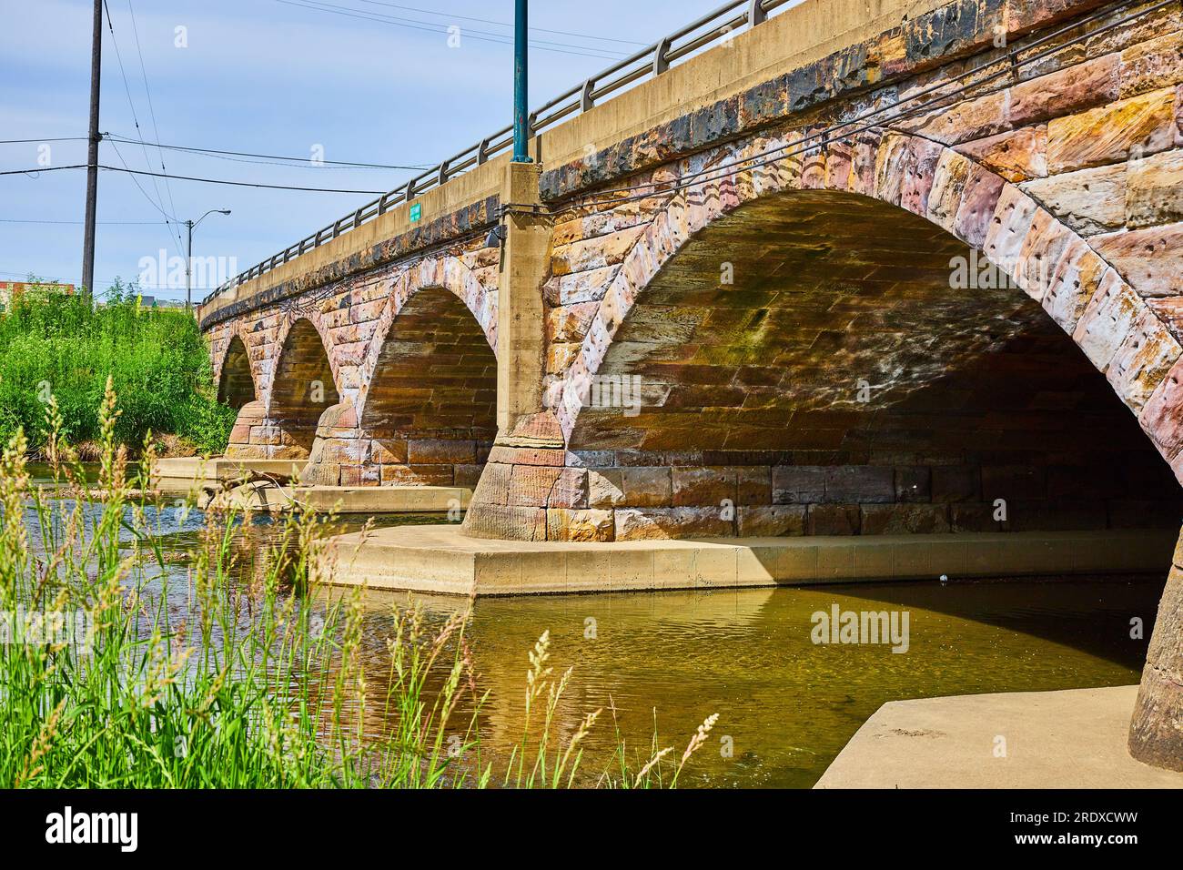 Gorgeous old stone bridge with stone arch underside and river flowing ...