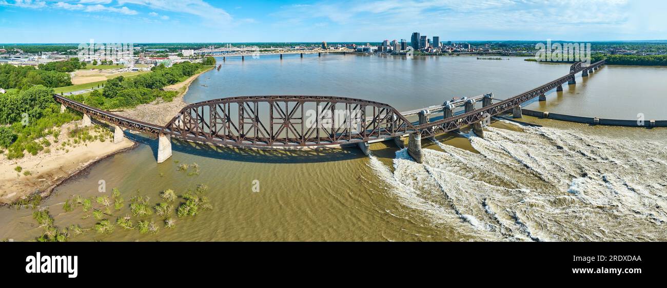 Panoramic railroad bridge next to Ohio River dam distant bridges and ...
