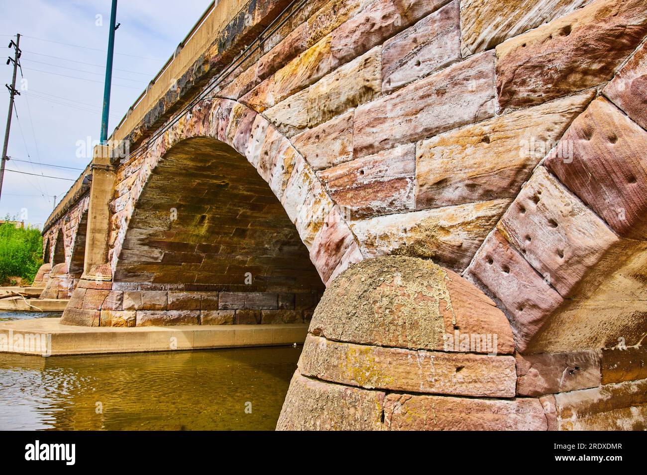 Large arches under brick bridge with gorgeous white gold hues and ...