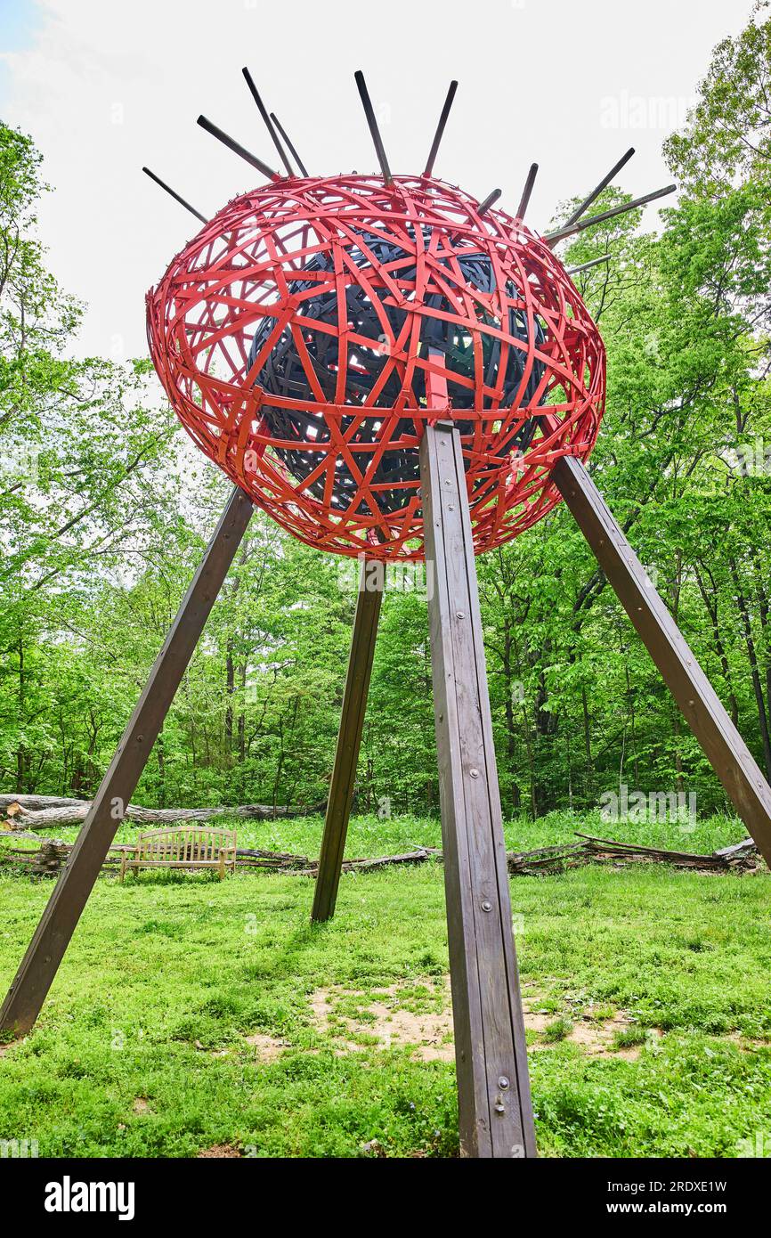 View from below of abstract red eye sculpture with red and black metal ...