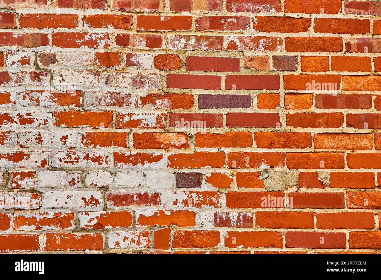Fierce orange and red brick wall with exposed white of underlying ...