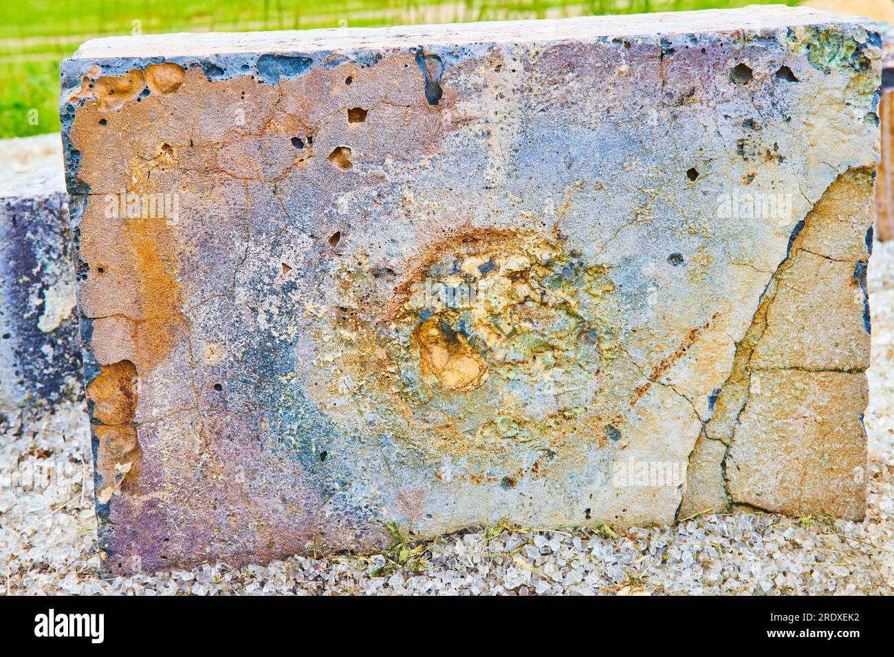 Explosion blasted concrete block with chemical bursts of color and ...