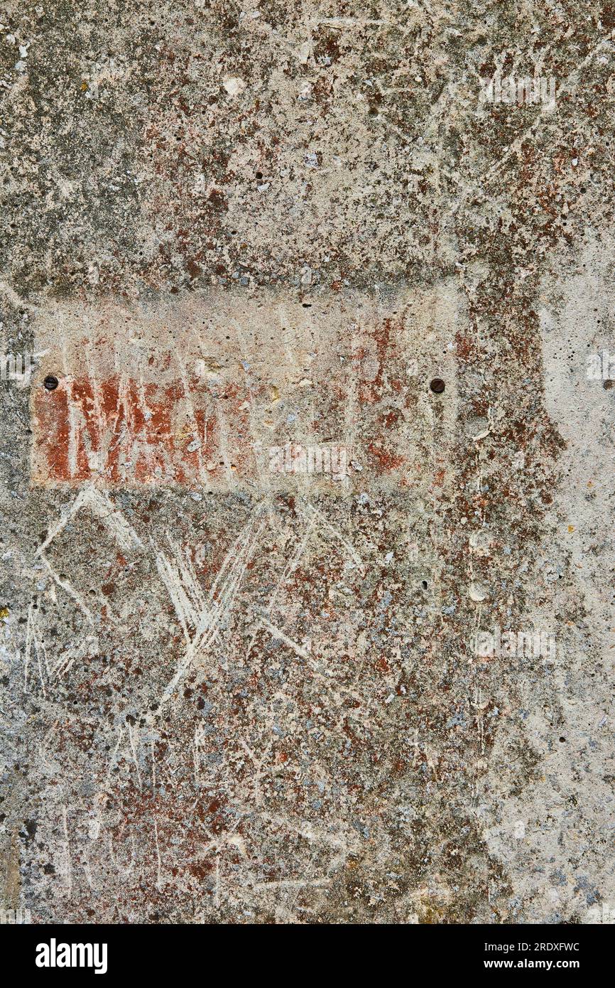 Scratched up concrete wall with rust and dirt stains corroding and ...