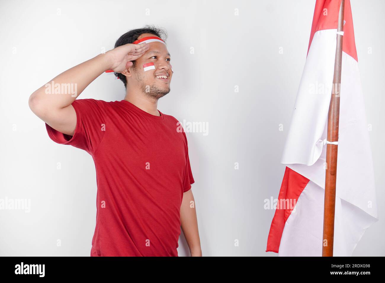 Indonesian man give salute with proud gesture while holding Indonesia's ...