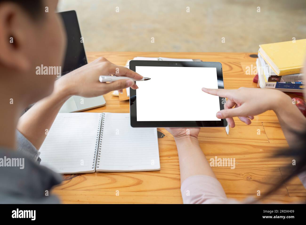 Mockup image of two student holding black tablet with blank desktop ...