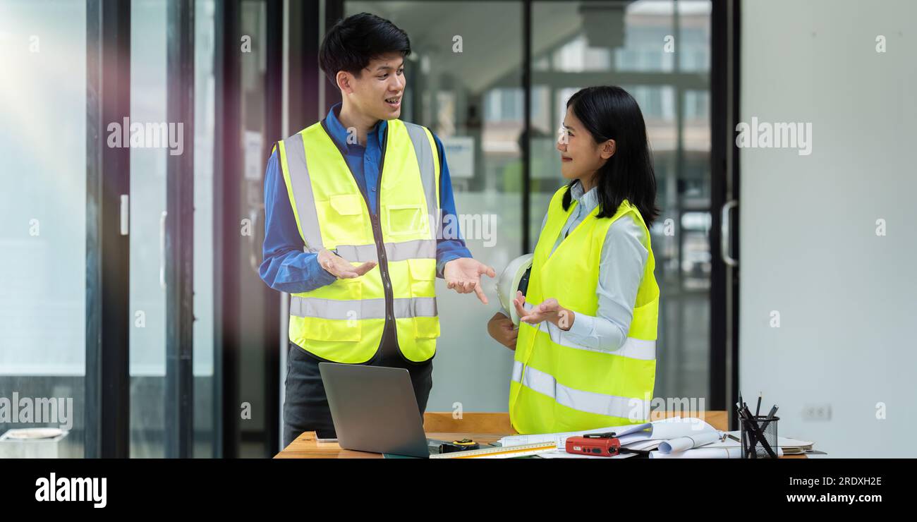 Civil engineers and architects discuss project construction together at ...