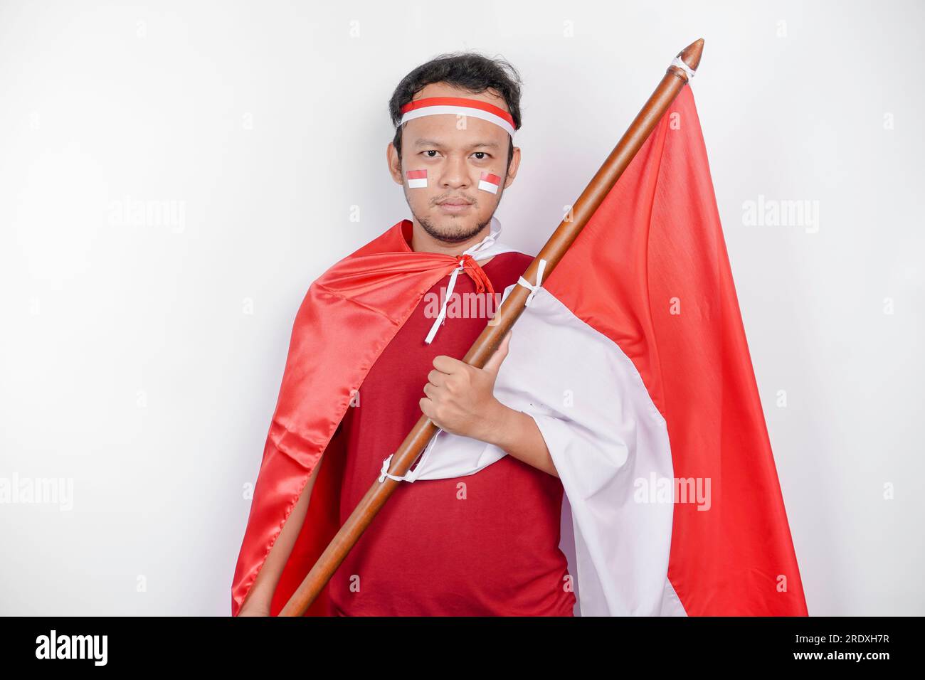 Happy smiling Indonesian man holding Indonesia's flag to celebrate ...