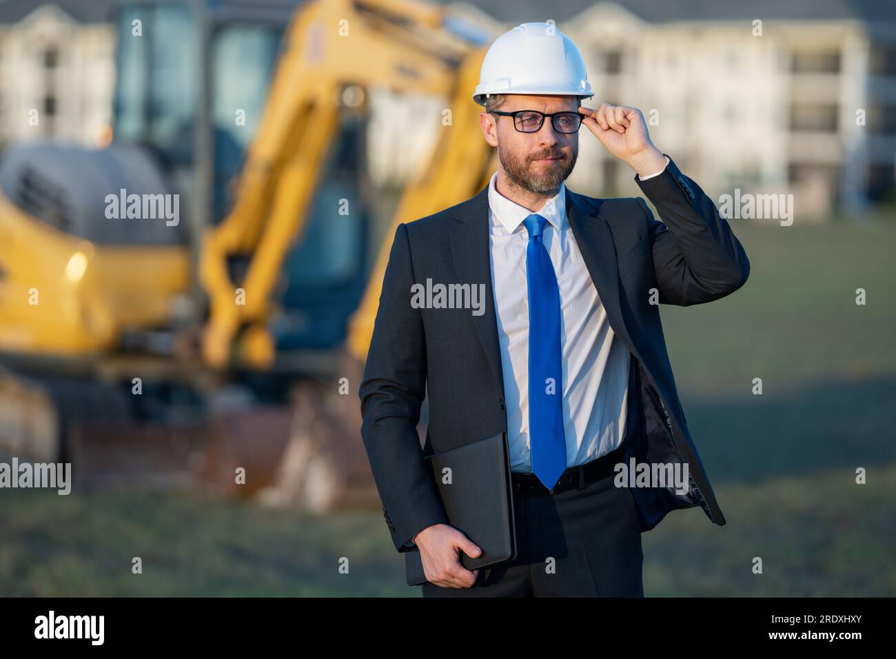 Successful construction business owner. Construction worker in suit and ...