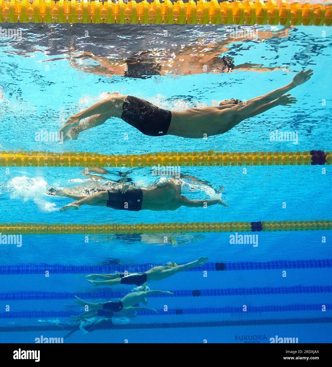 Thomas Ceccon, of Italy, competes in a men's 100-meter backstroke heat ...