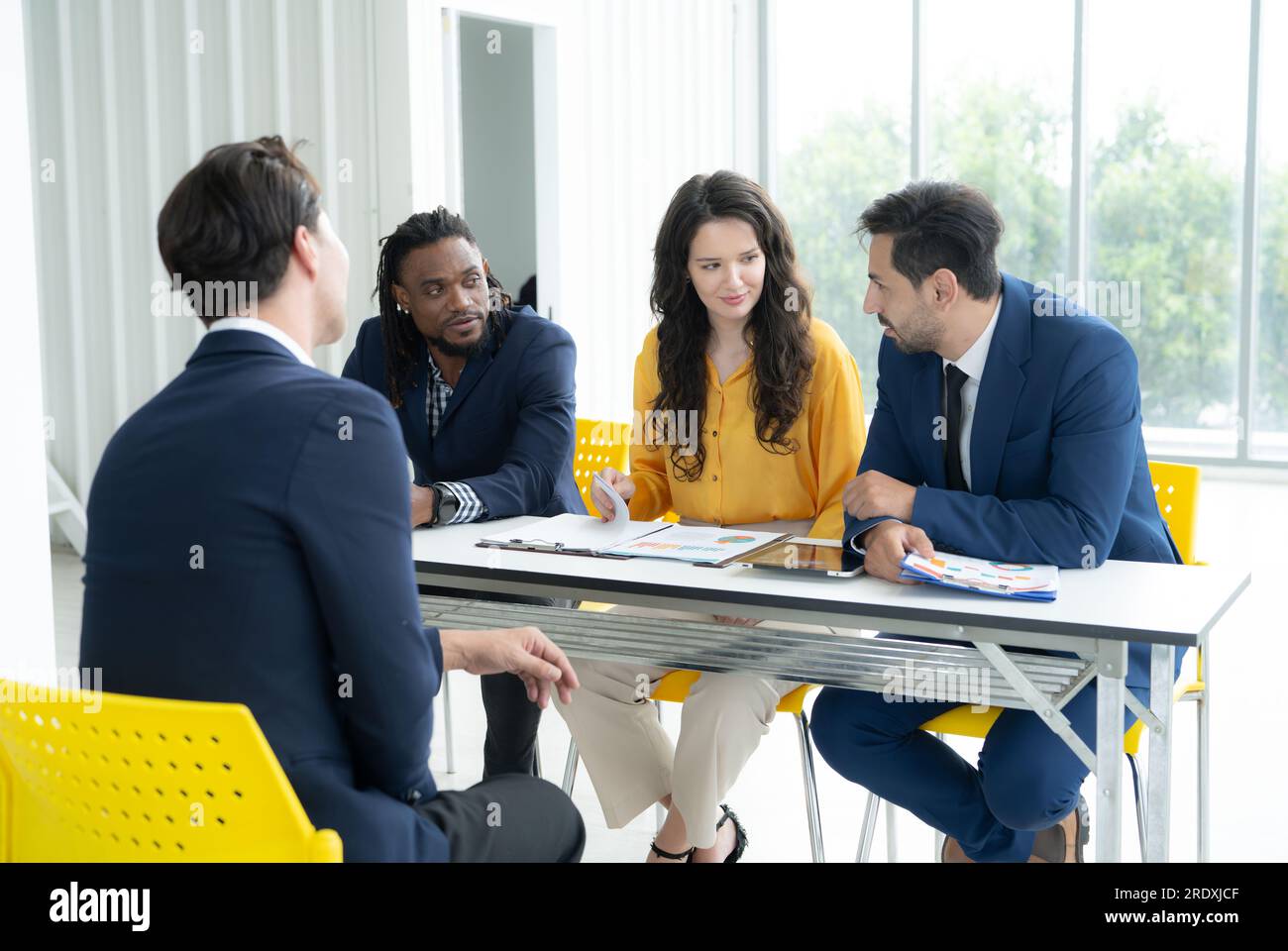 Job interview concept. Diverse hr team doing job interview with a man ...