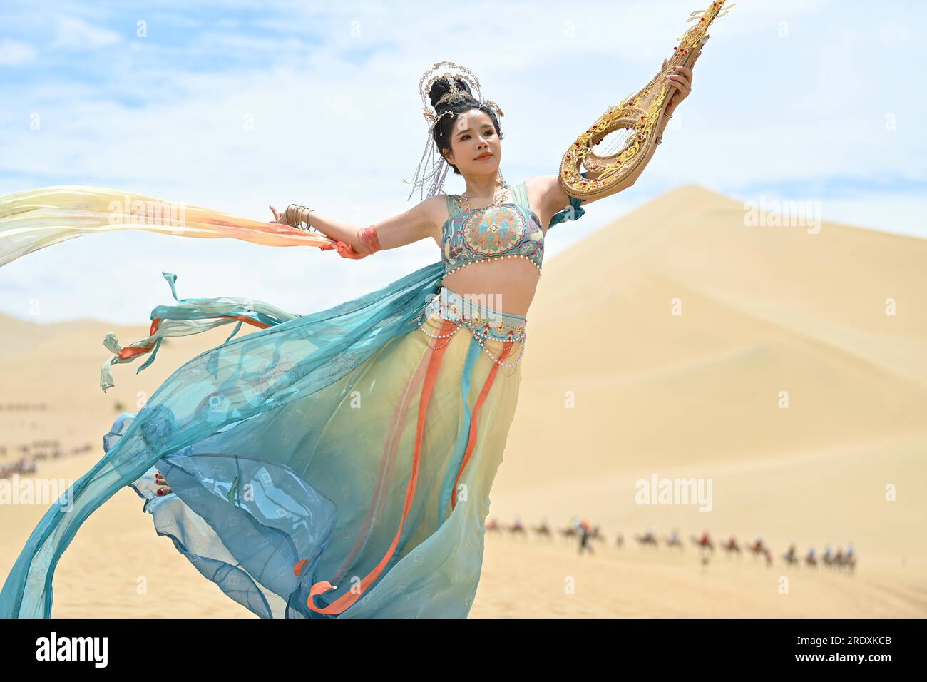 **CHINESE MAINLAND, HONG KONG, MACAU AND TAIWAN OUT** Tourists wear Dunhuang Flying Apsaras ...
