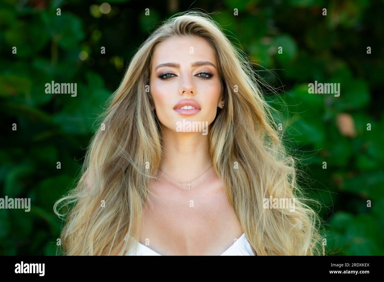 Beautiful young girl relaxing in spring park. Close up portrait of ...