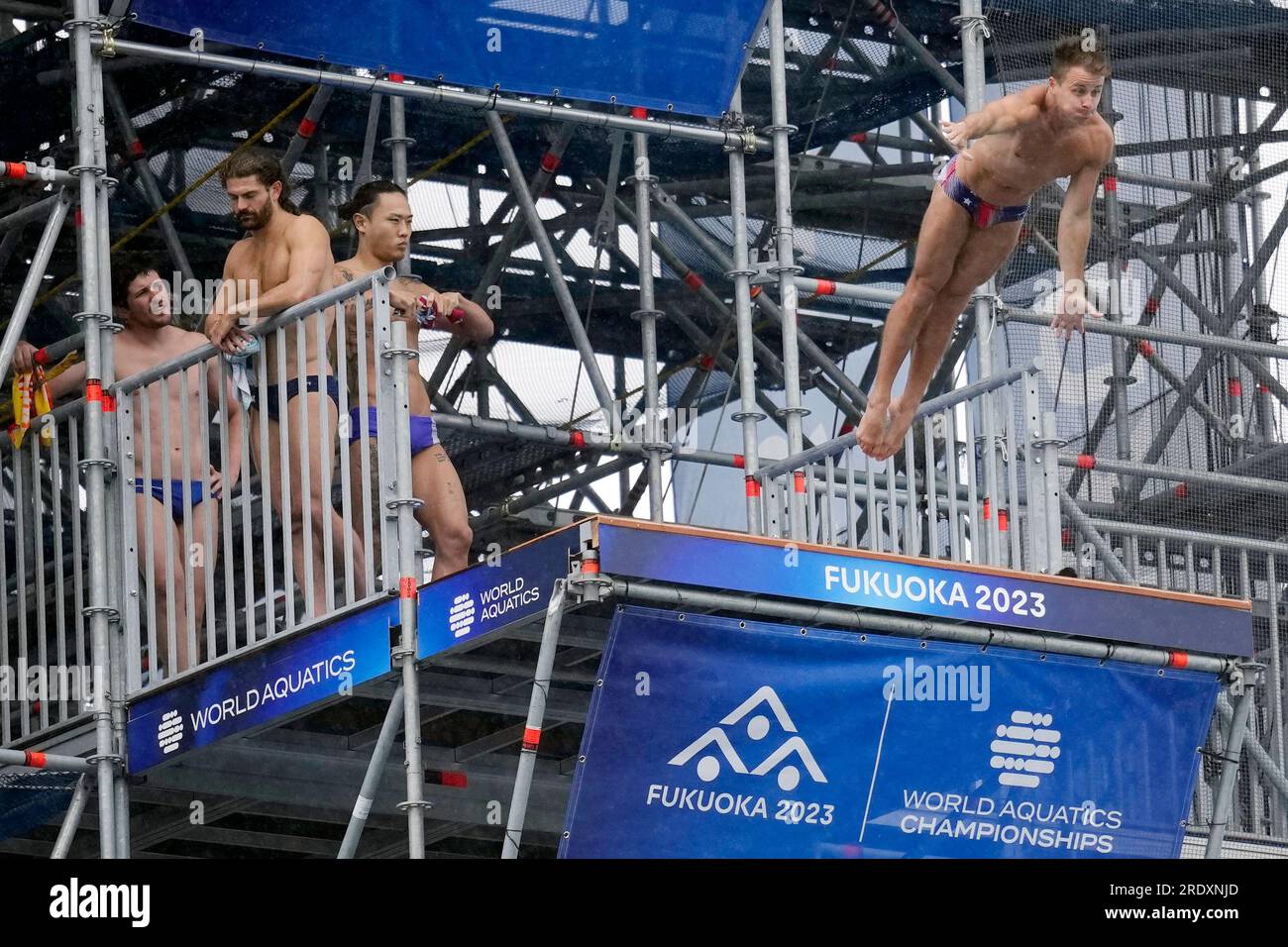 Matt Cooper, right, of the Unites States dives during a practice ...