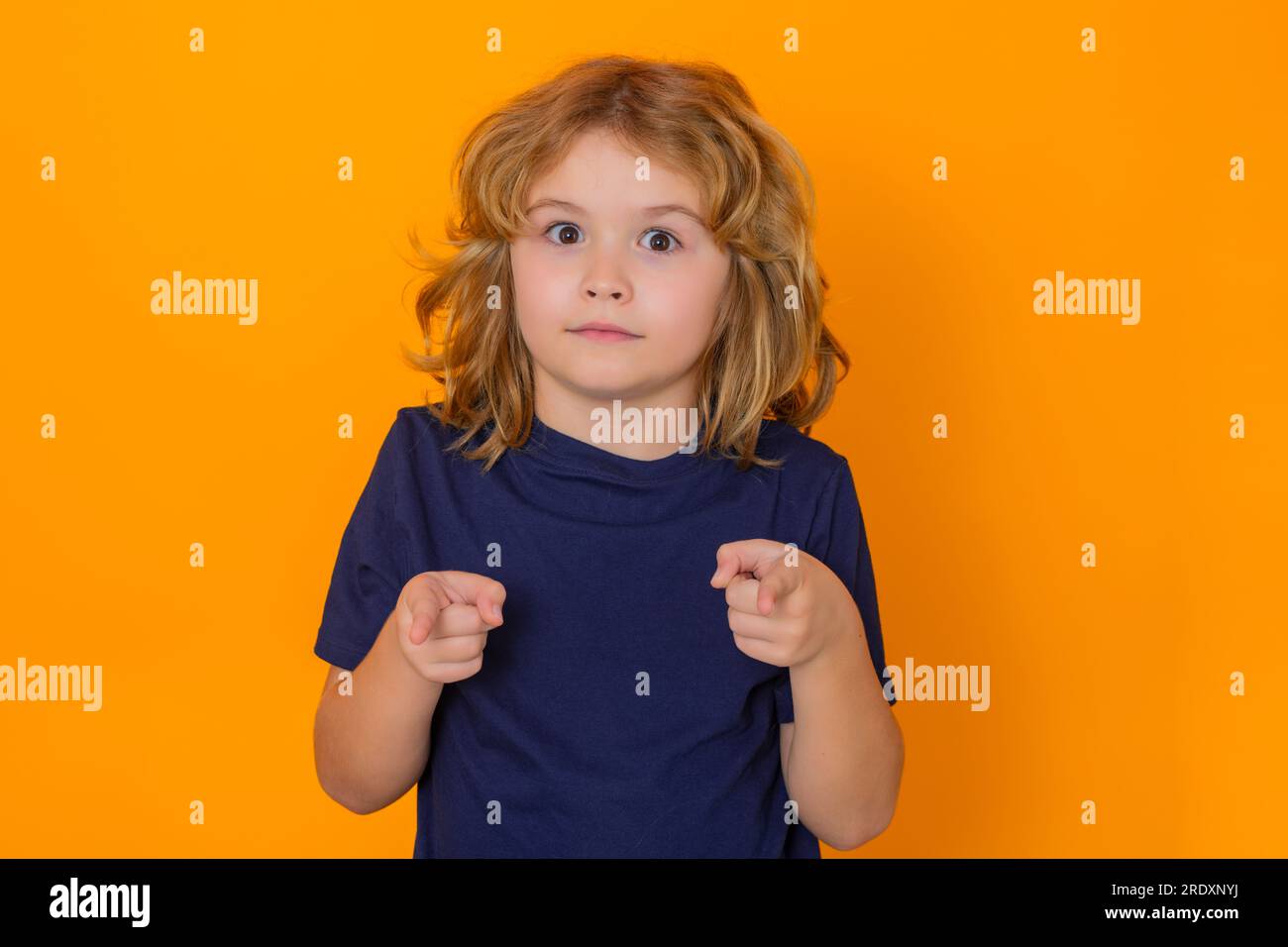 Child boy pointing you on yellow isolated studio background. Shocked ...