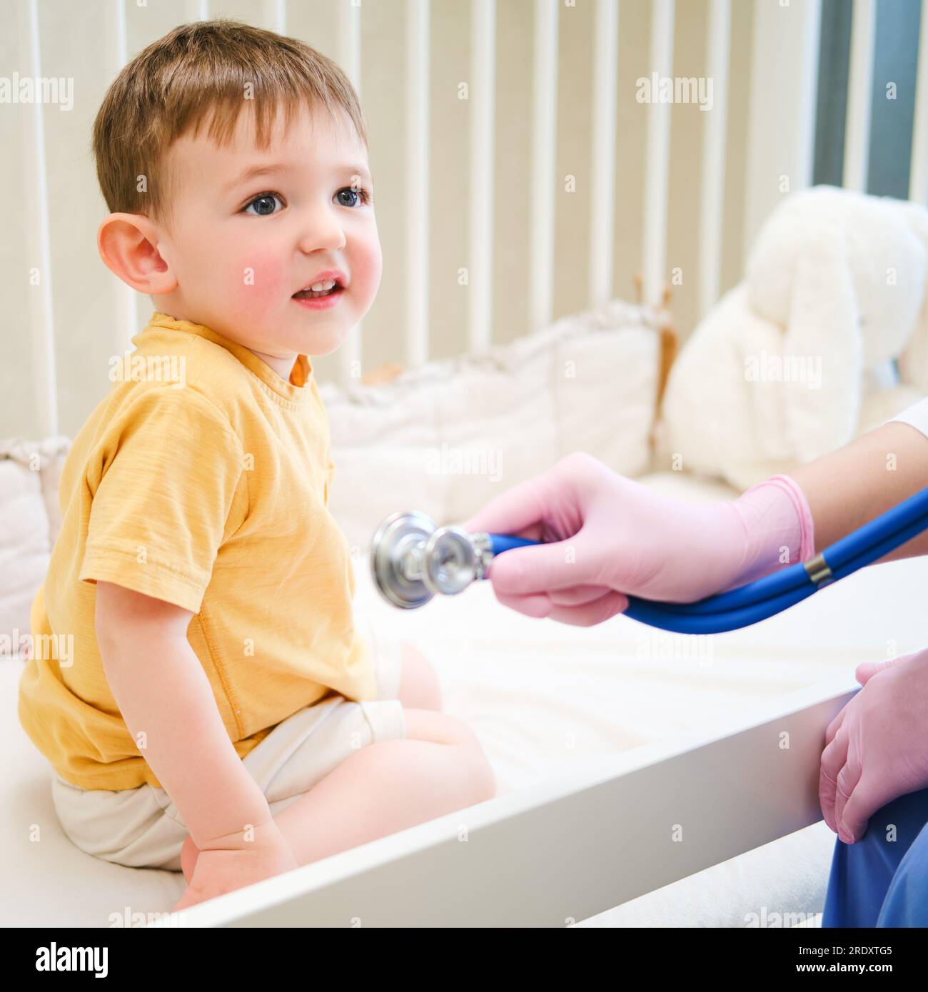 The doctor instructed the boy to take deep breaths while he listened to ...