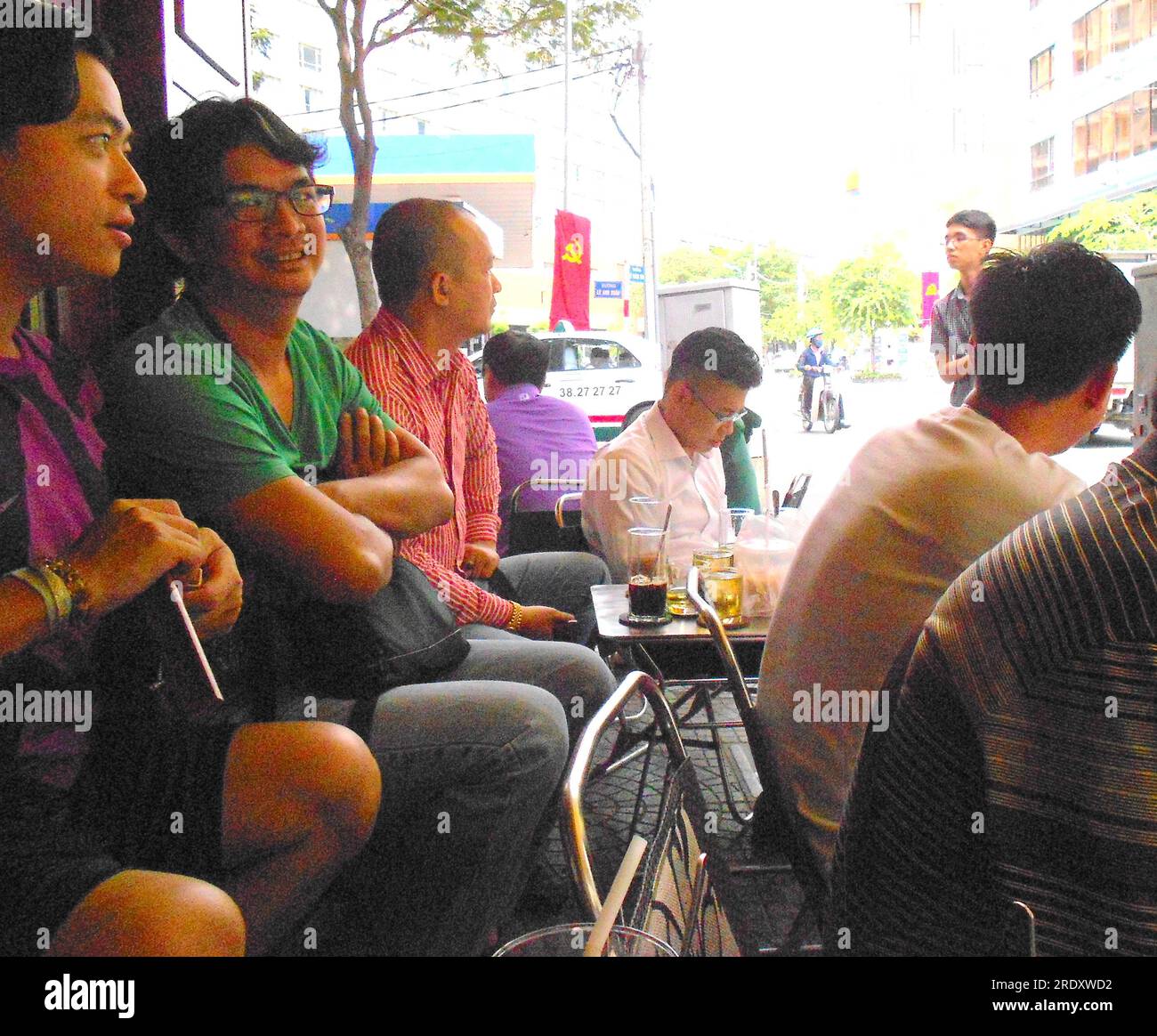 men drink coffee in front of coffee shop, noisy image, Ho Chi Minh City ...