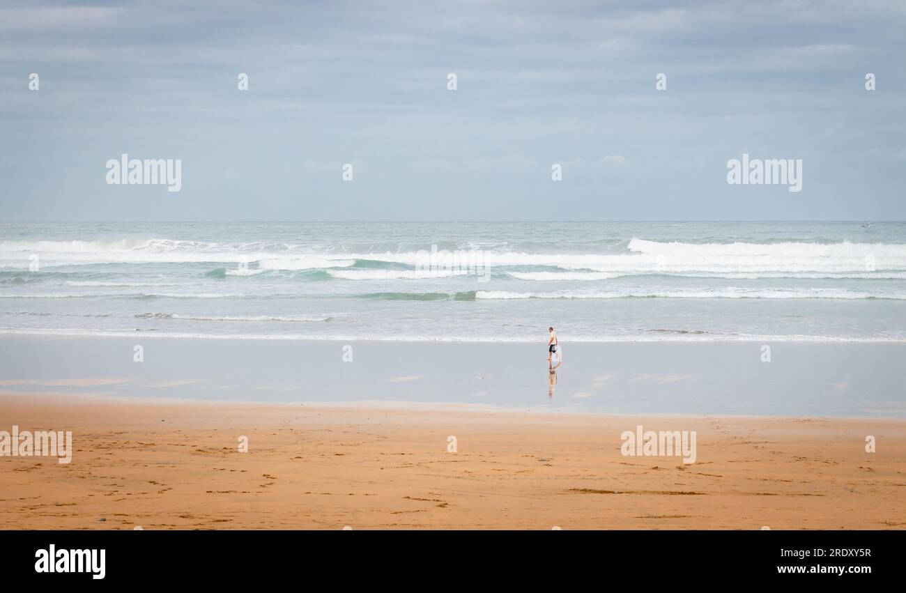 Walking people on wide beach of Biscayne bay, Spain. Surf beach with ...