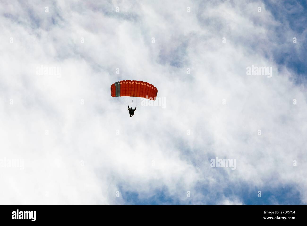 Parachute in the sky. Skydiver is flying a parachute in the blue sky ...
