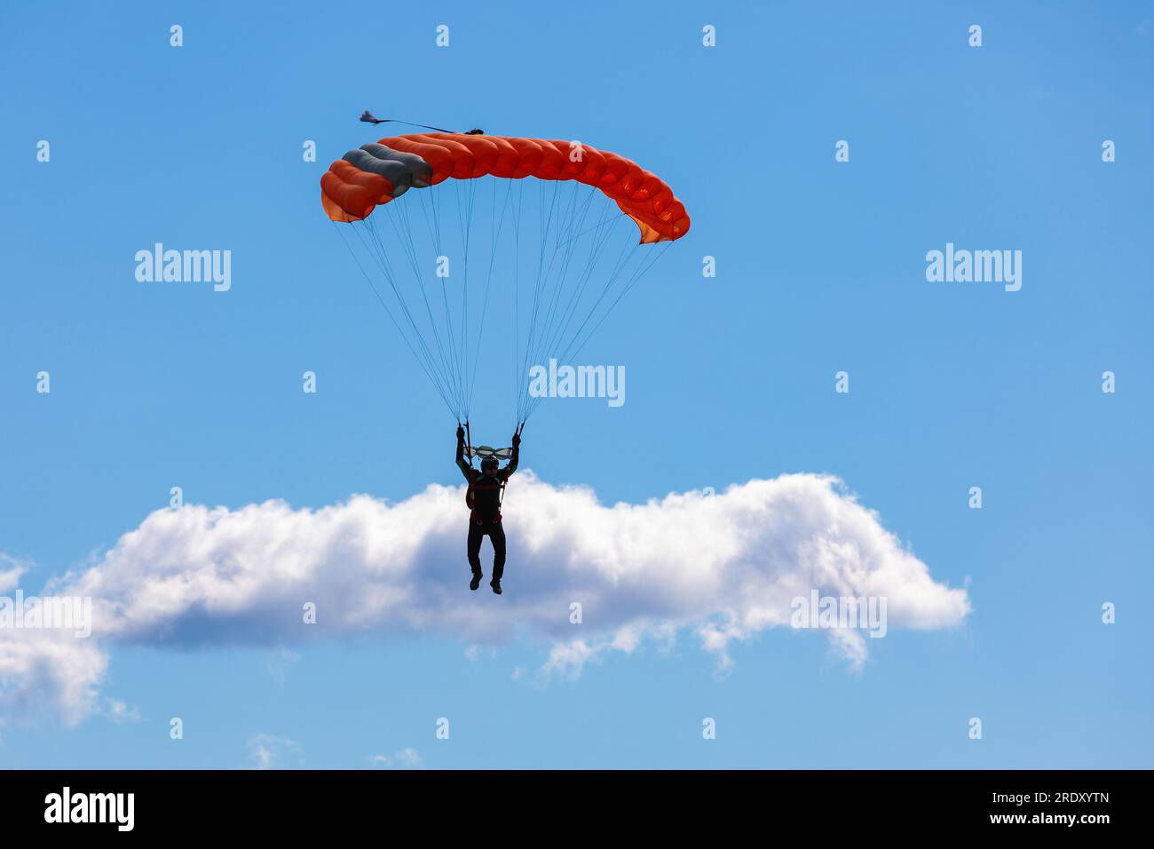 Parachute in the sky. Skydiver is flying a parachute in the blue sky ...