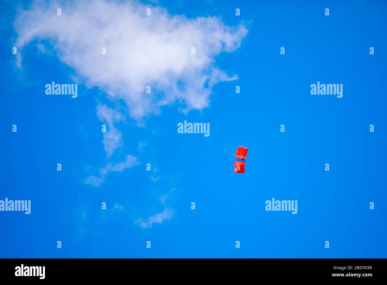 Parachute in the sky. Skydiver is flying a parachute in the blue sky ...