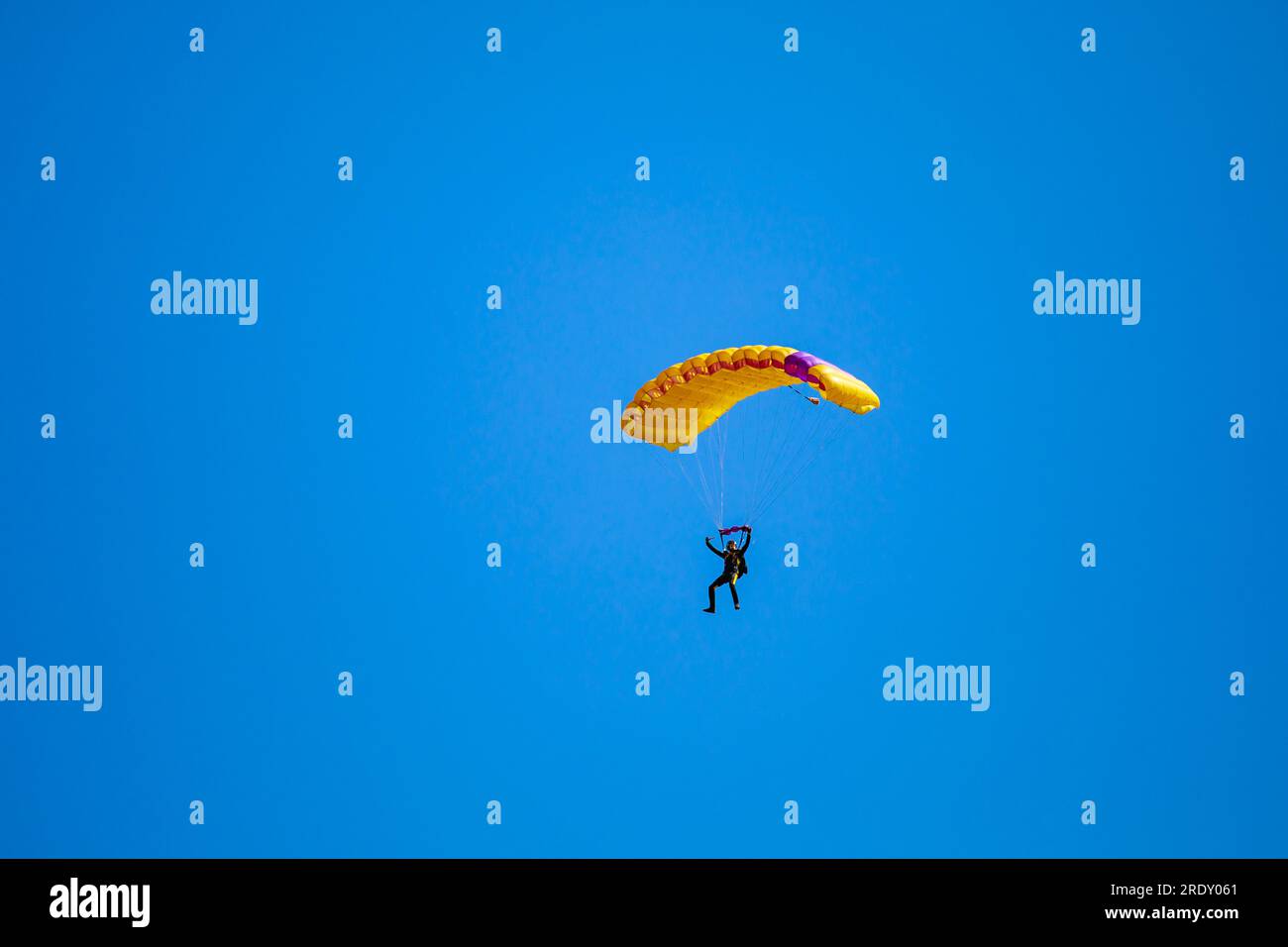 Parachute in the sky. Skydiver is flying a parachute in the blue sky ...