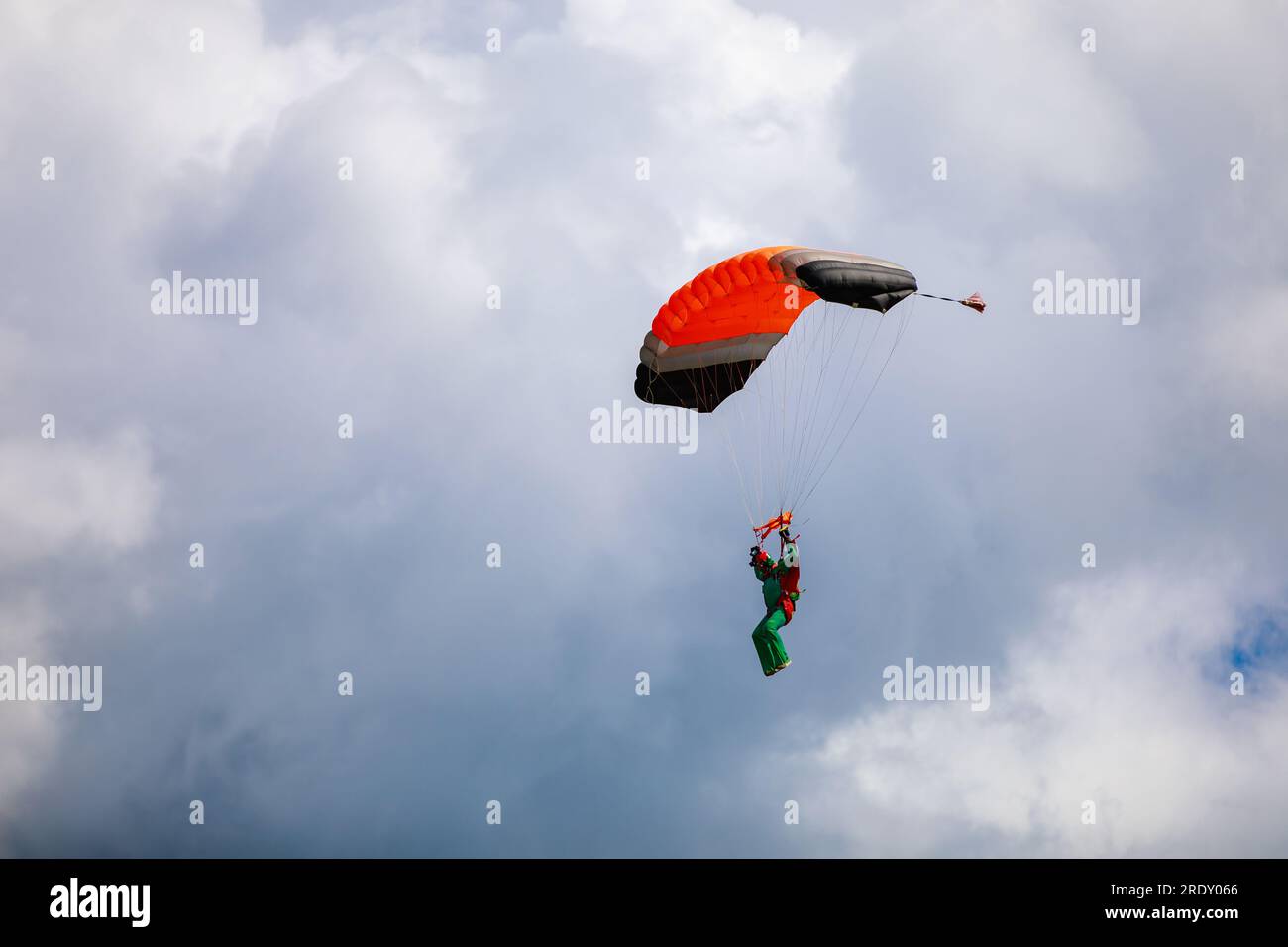 Parachute in the sky. Skydiver is flying a parachute in the blue sky ...