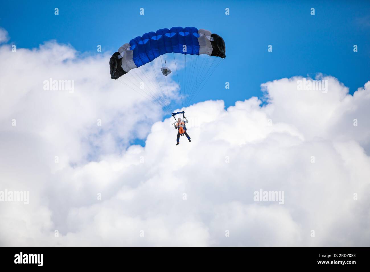 Parachute in the sky. Skydiver is flying a parachute in the blue sky ...
