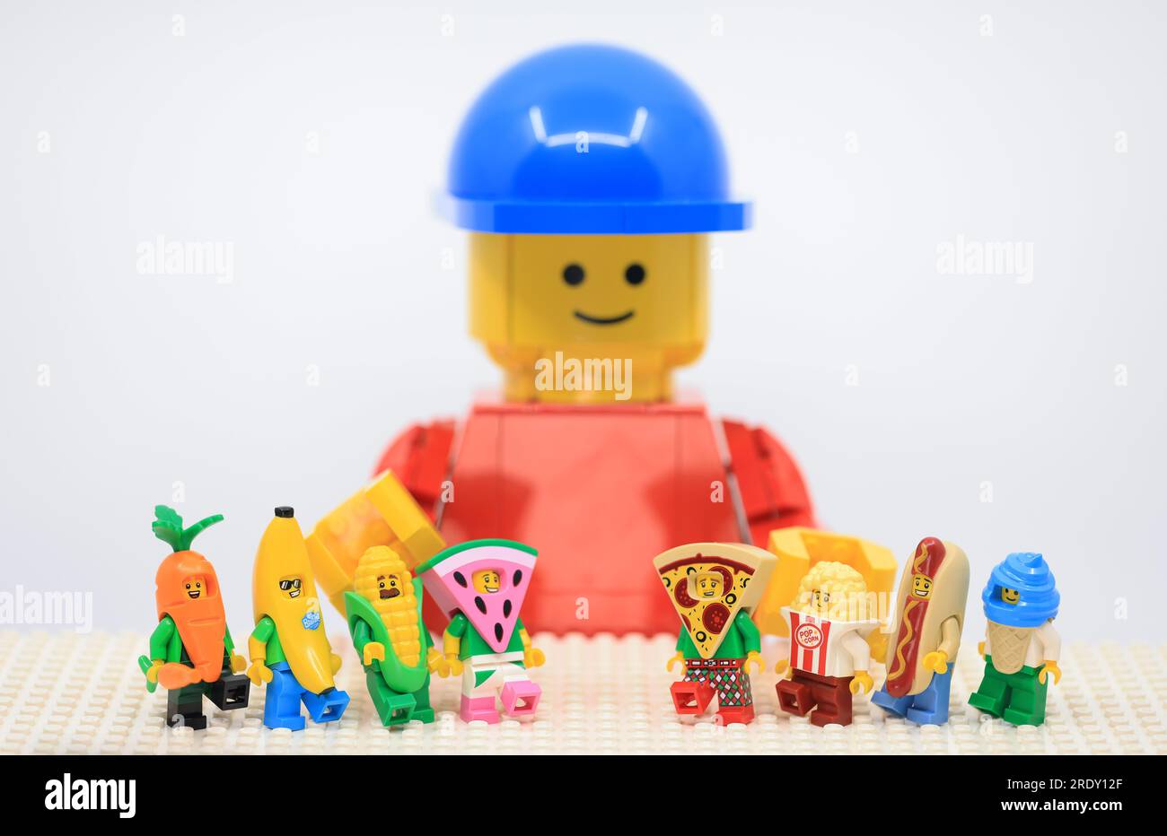 giant man pick a side between snack and healthy food on the table with ...