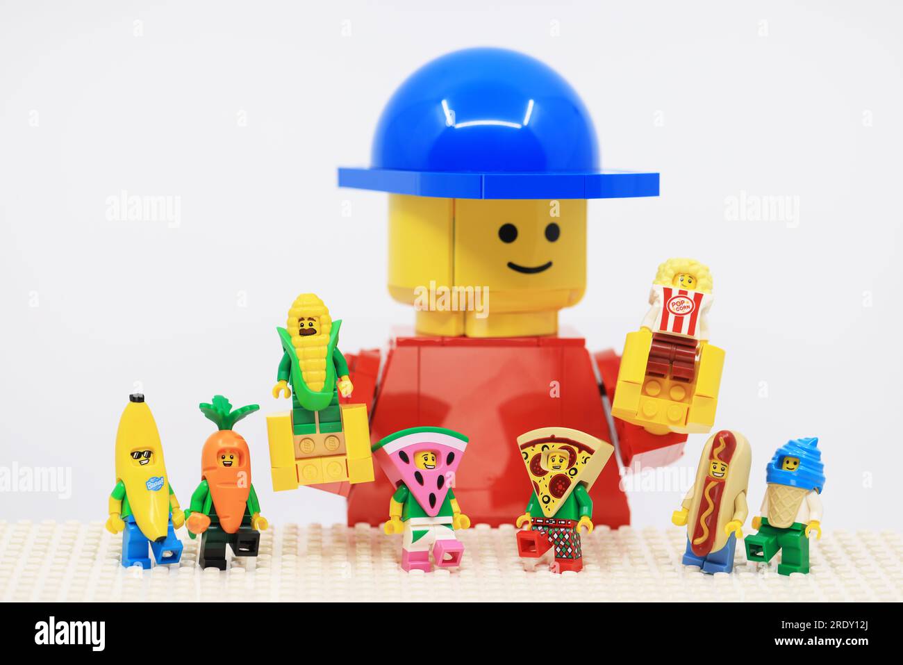 giant man pick a side between snack and healthy food on the table with ...