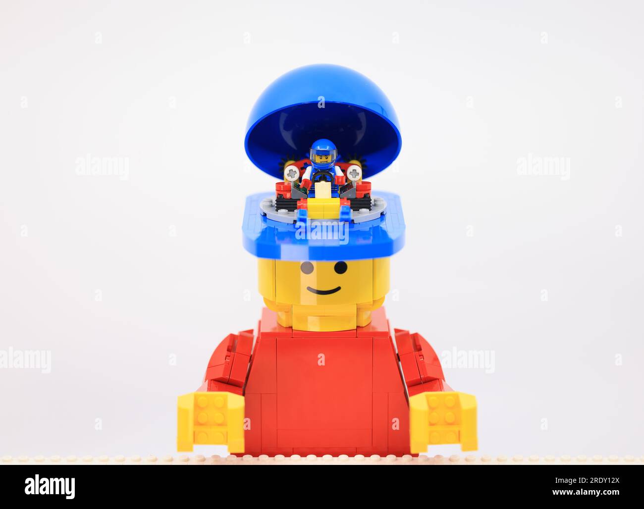 giant man have a mini boy inside his head as a racer Stock Photo - Alamy