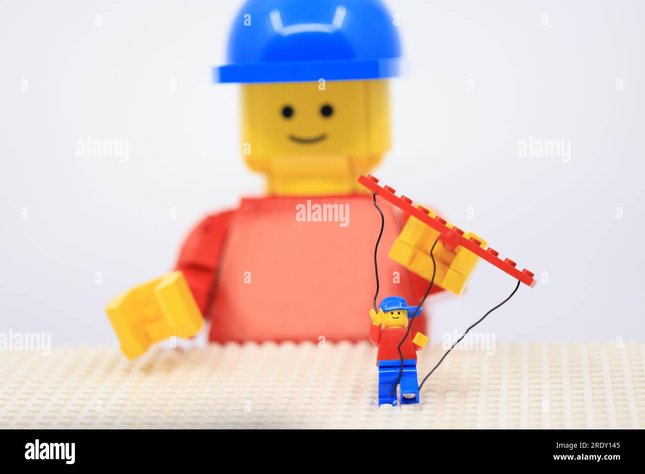 Giant man pick up the small one in the crowded people Stock Photo - Alamy