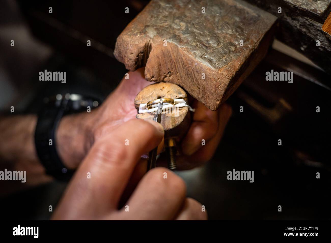 Jeweler hands setting a diamond into a ring with a burin. Goldsmith ...