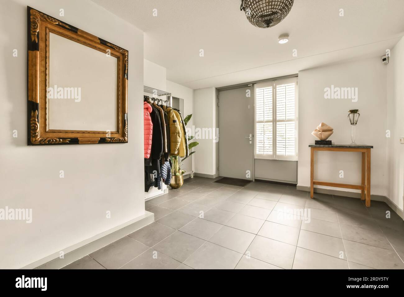 a walk - in closet with clothes hanging on the wall and an open door ...