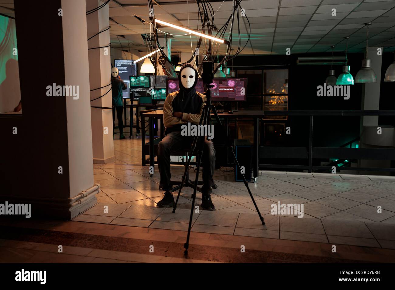 Hacker with mask threatening to expose important data on live broadcast ...